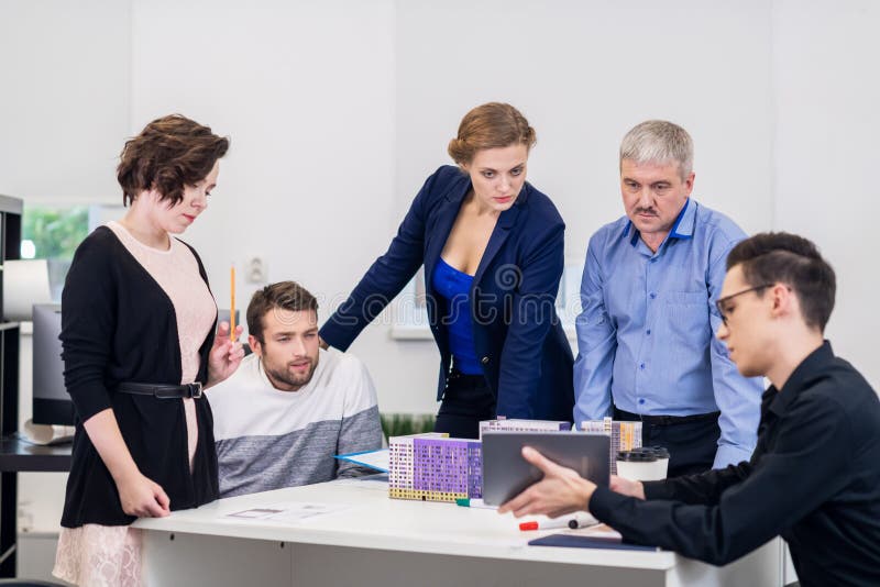 A Group of Five People Brainstorming in the Office Stock Photo - Image ...