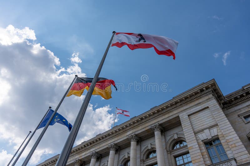 A Group of Flags are Flying in the Sky Above a Building Stock Photo ...