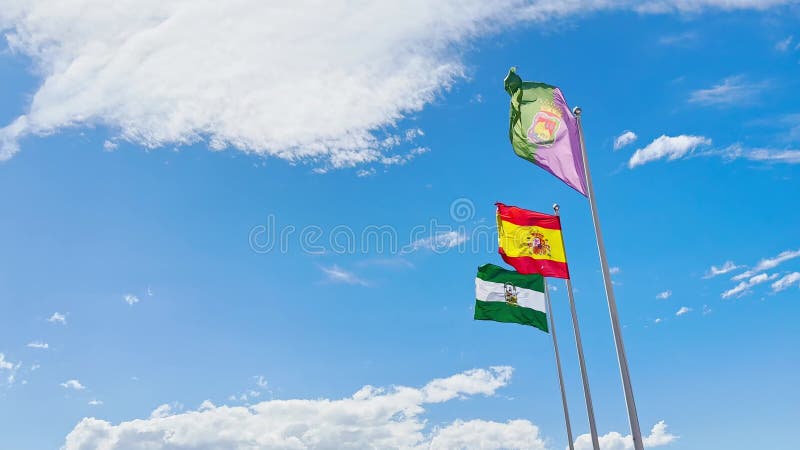 National Spanish Flags Waving in the Vibrant Blue Sky at Malaga Stock ...