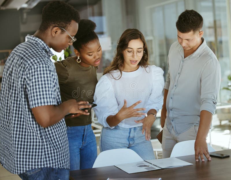 Group of Focused Businesspeople Standing and Talking Together in an ... Group of Focused Businesspeople Standing and Talking Together in an ...