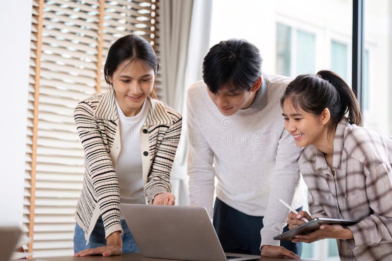 Collaborative Learning and Research. Three Students Leaning Over a ...