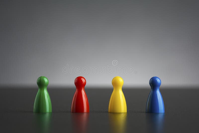 Group of Four Figurines in Different Colors in a Row Stock Image ...