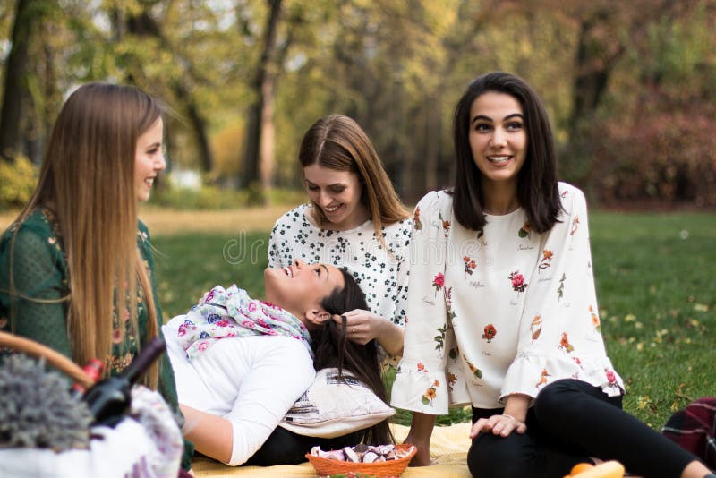 Group of Four Young Women Having a Picnic in the Park. Stock Image ... Group of Four Young Women Having a Picnic in the Park. Stock Image ...