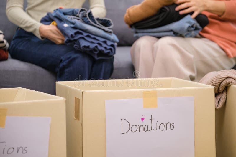 Group of Friend Sorting and Packing Clothes into a Donation Box.community Support, and ...