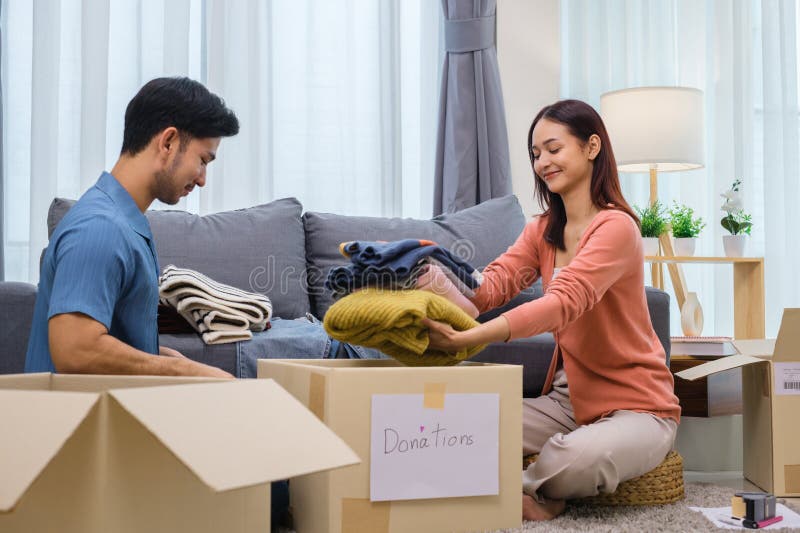 Group of Friend Sorting and Packing Clothes into a Donation Box ...