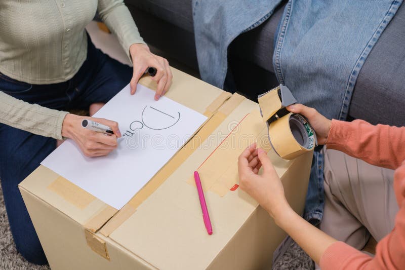 Group of Friend Sorting and Packing Clothes into a Donation Box ...