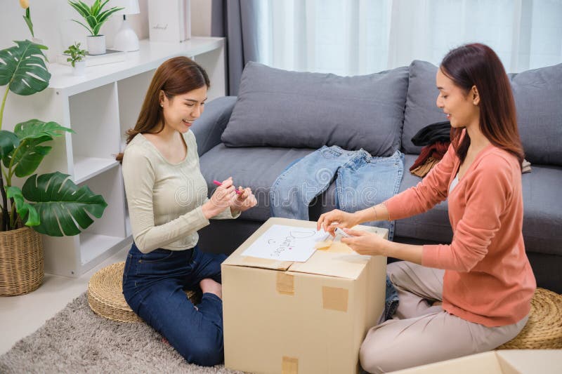 Group of Friend Sorting and Packing Clothes into a Donation Box ...