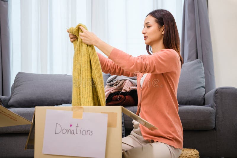 Group of Friend Sorting and Packing Clothes into a Donation Box ...