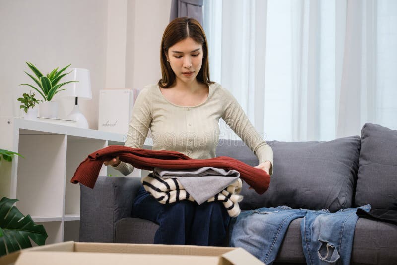 Group of Friend Sorting and Packing Clothes into a Donation Box ...