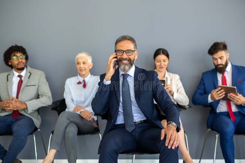 Group of Friendly Businesspeople with Male Leader in Front Stock Photo ...