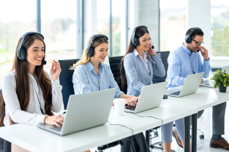 Group of Friendly Customer Support Operators Working at Call Center ...
