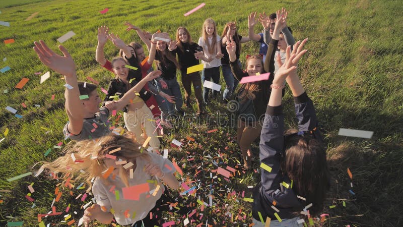 A Group of Friendly Friends Toss Up Candy at Sunset in a Field. Stock ...