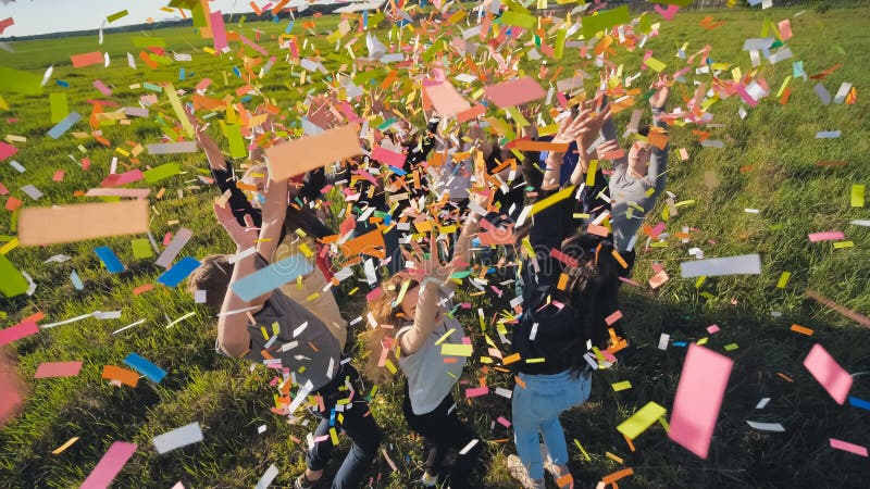 A Group of Friendly Friends Toss Up Candy at Sunset in a Field. Stock ...