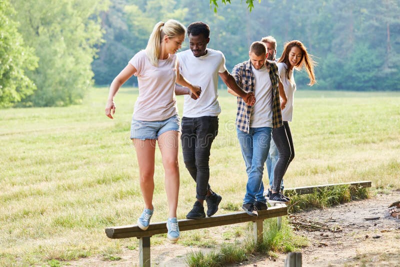 Group of Friends Balancing on Beams Stock Photo - Image of teambuilding ...