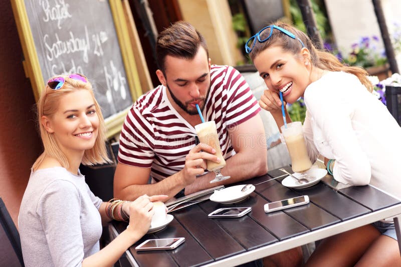 Group of friends in a cafe stock image. Image of pretty - 56305393