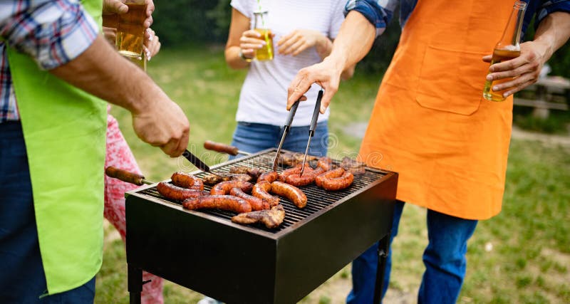 Group of Friends Camping and Having a Barbecue in Nature Stock Photo ...