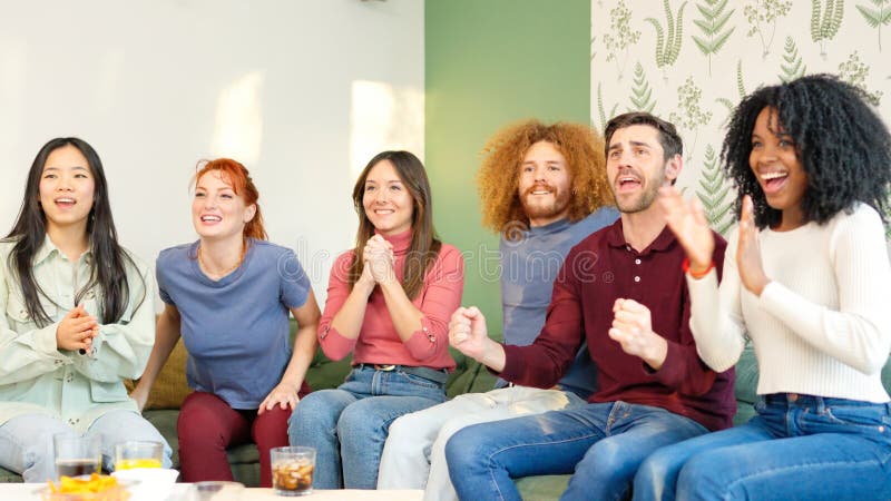 Group of Friends Celebrating Something they are Watching on TV Stock ...