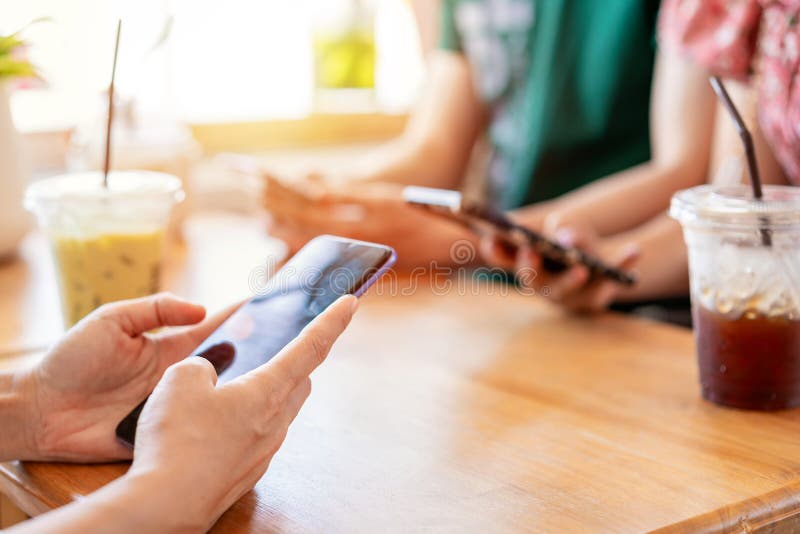 Group of Friends with Drinks Checking Social Media on Smartphones Stock ...