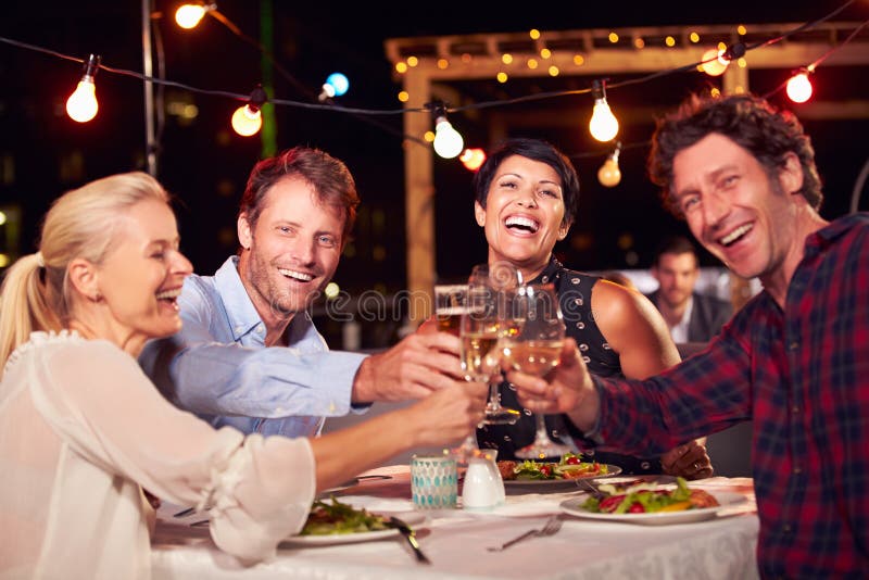 Group of Friends Eating Dinner at Rooftop Restaurant Stock Image ...