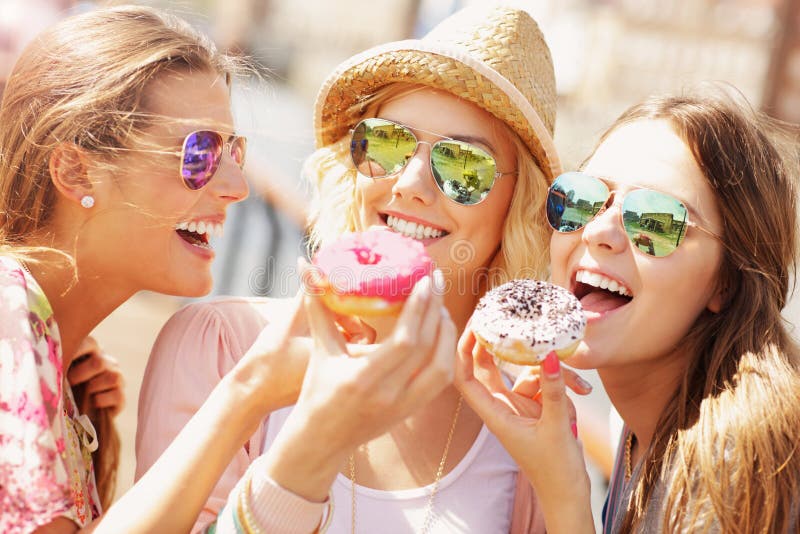 Group of Friends Eating Donuts in the City Stock Photo - Image of ...