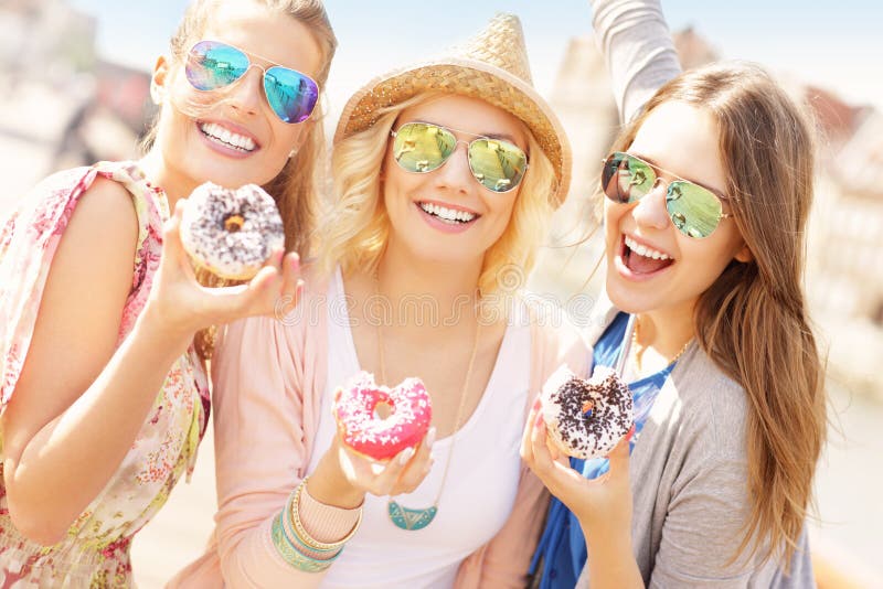 Group of Friends Eating Donuts in the City Stock Photo - Image of ...
