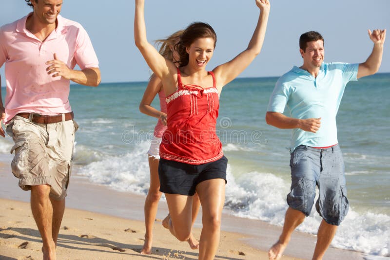Group Of Friends Enjoying Beach Holiday In The Sun Stock Image - Image ...