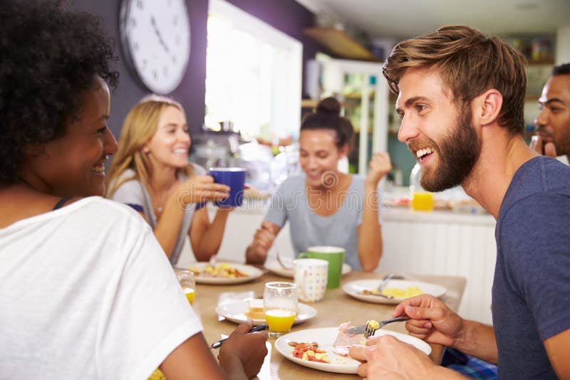 Group of Friends Enjoying Breakfast in Kitchen Together Stock Photo ...