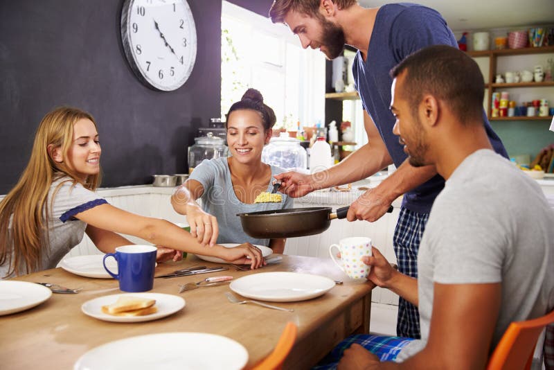 Group of Friends Enjoying Breakfast in Kitchen Together Stock Photo ...
