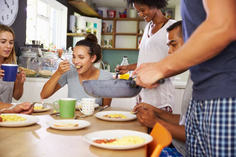 Group of Friends Enjoying Breakfast in Kitchen Together Stock Photo ...