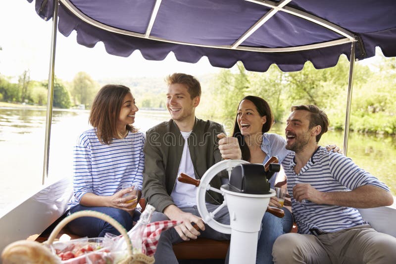 Group of Friends Enjoying Day Out in Boat on River Together Stock Photo ...