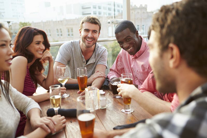 Group of Friends Enjoying Drink at Outdoor Rooftop Bar Stock Photo ...