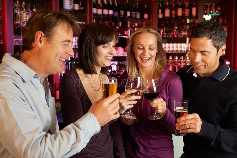 Group of Friends Enjoying Drinks Together in Bar Stock Image - Image of ...