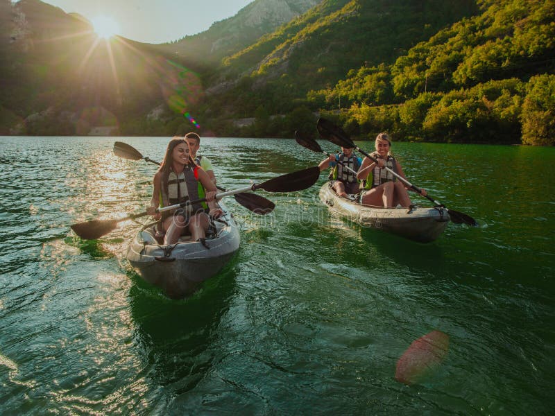 A Group of Friends Enjoying Fun and Kayaking Exploring the Calm River ...
