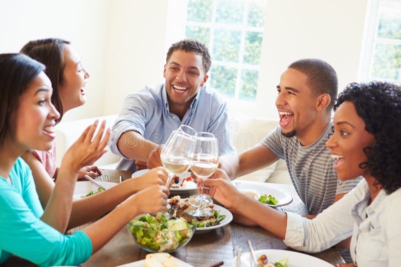 Group of Friends Enjoying Meal at Home Together Stock Photo - Image of ...