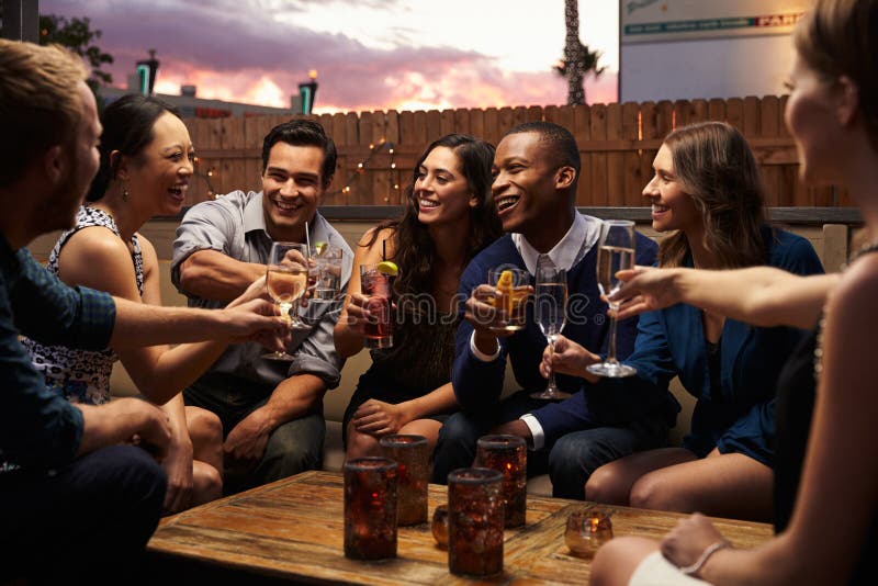 Group of Friends Enjoying Night Out at Rooftop Bar Stock Photo - Image ...