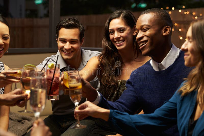 Group of Friends Enjoying Night Out at Rooftop Bar Stock Image - Image ...