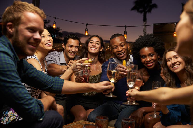Group of Friends Eating Dinner at Rooftop Restaurant Stock Photo ...