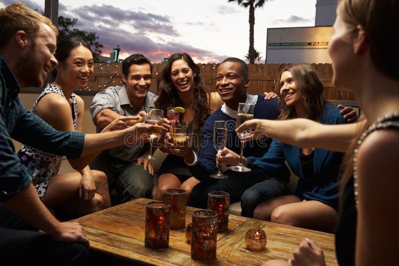 Group of Friends Enjoying Night Out at Rooftop Bar Stock Photo - Image ...