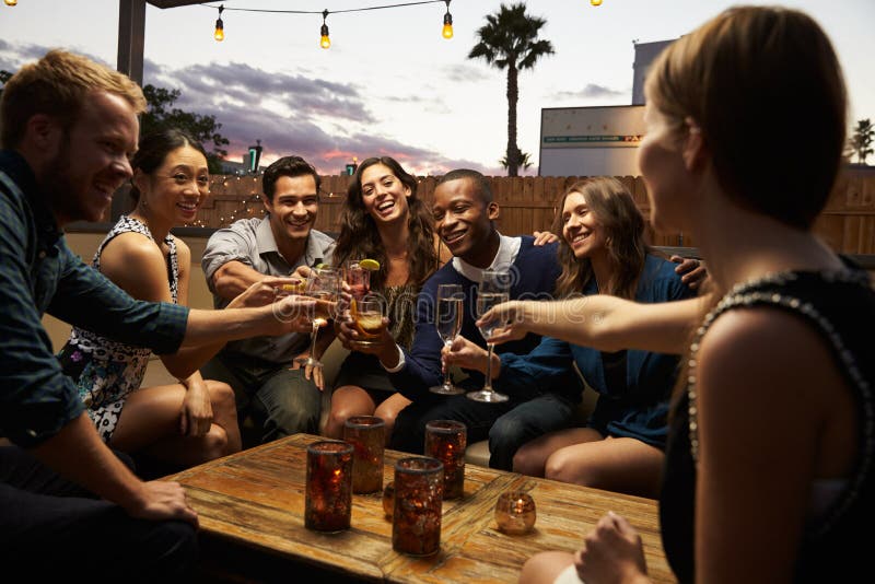 Group of Friends Enjoying Night Out at Rooftop Bar Stock Image - Image ...