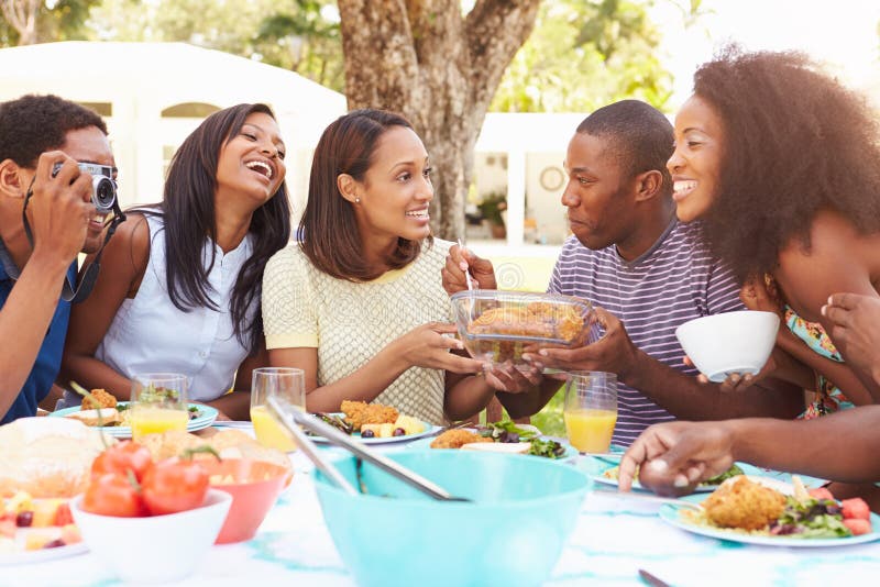 Group of Friends Enjoying Outdoor Meal at Home Stock Image - Image of ...