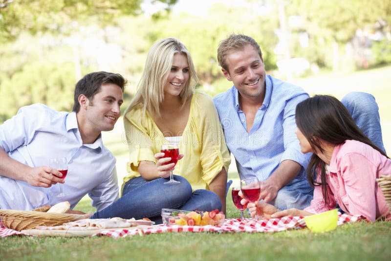 Group of Friends Enjoying Picnic Together Stock Image - Image of people ...