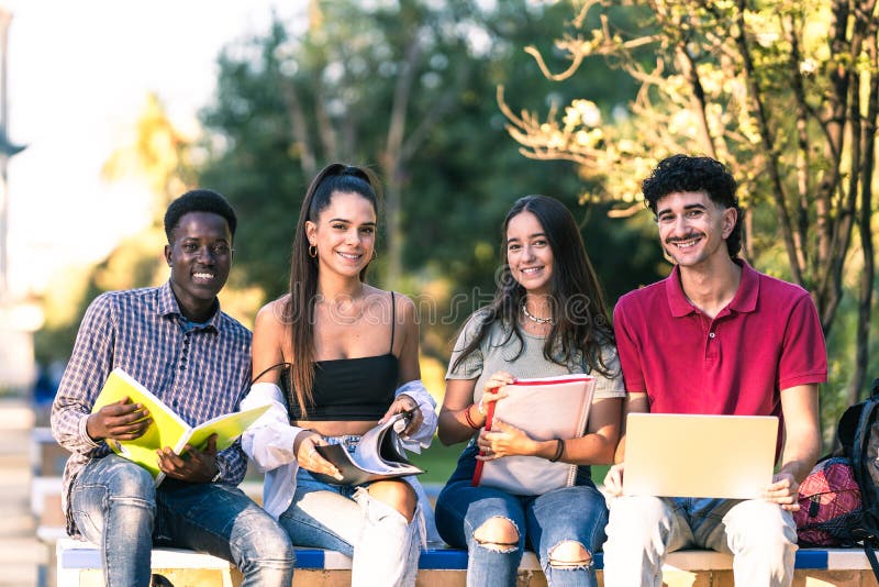 Group of Friends Facing the Camera while Sitting on a Bench with ...