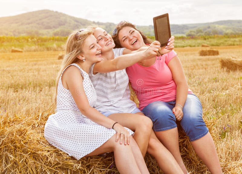 Group of Friends in a Field Taking a Picture with a Tablet Stock Photo ...