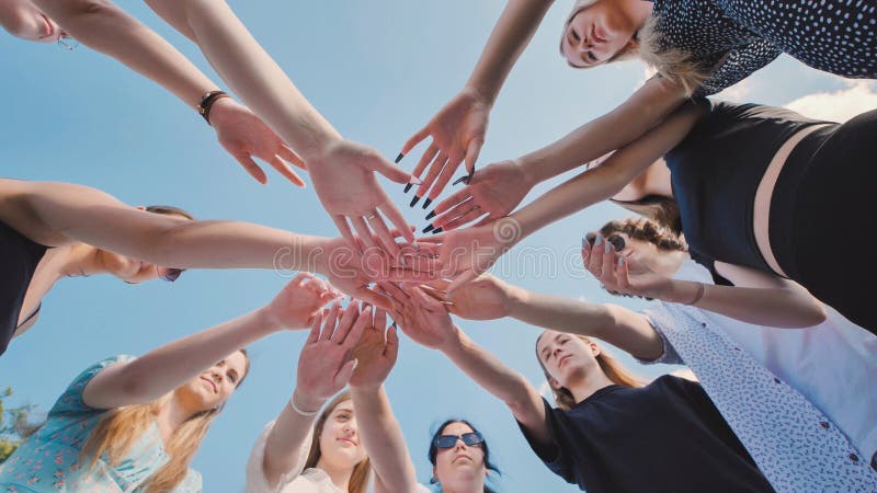 Group of Friends Forming a Circle Joining Hands Together Outdoors in a ...