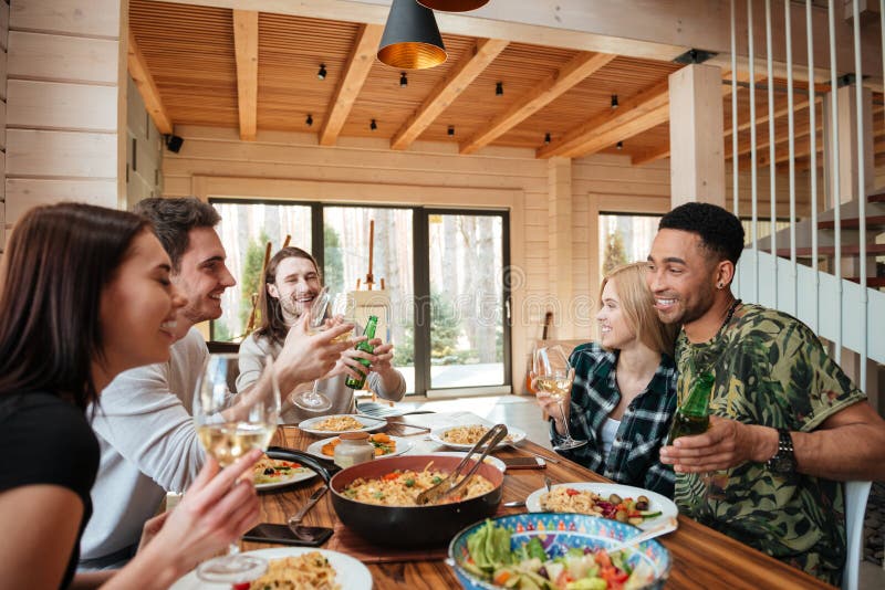 Group of Friends Having Dinner and Laughing at the Table Stock Photo ...