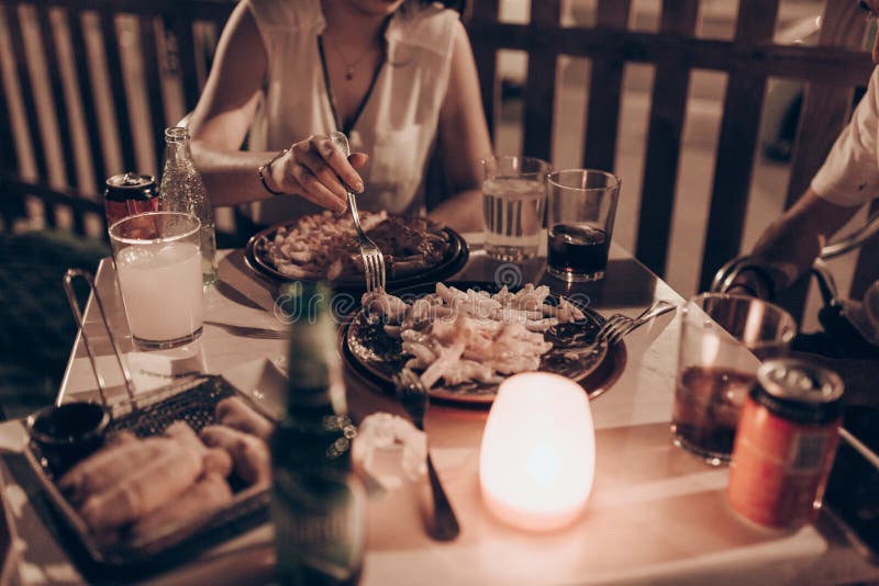 Group of Friends Having Dinner at Night on a Terrace in Summer ...