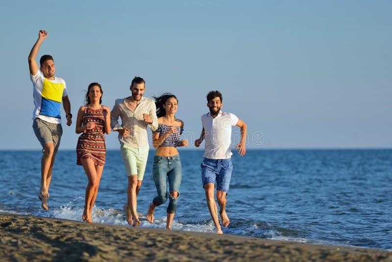 Group of Friends Having Fun Walking Down the Beach at Sunset Stock ...