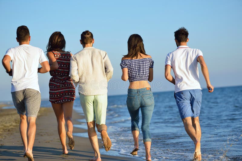 Group of Friends Having Fun Walking Down the Beach at Sunset Stock ...