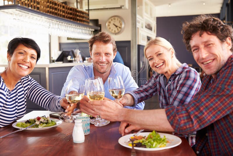 A Group of Friends Having Lunch in a Restaurant Stock Photo - Image of ...