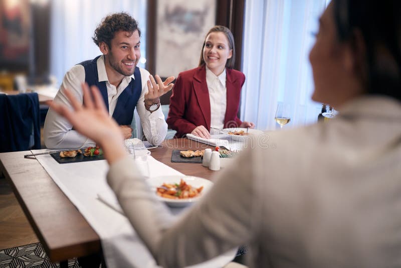 Group of Friends Having Lunch at the Restaurant, Talking, Smiling Stock ...